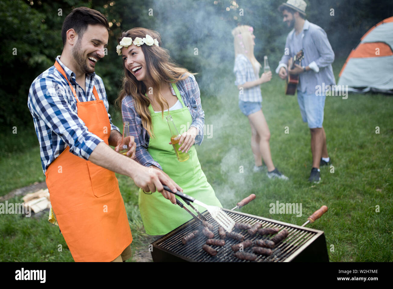 Group of friends making barbecue in the nature Stock Photo - Alamy