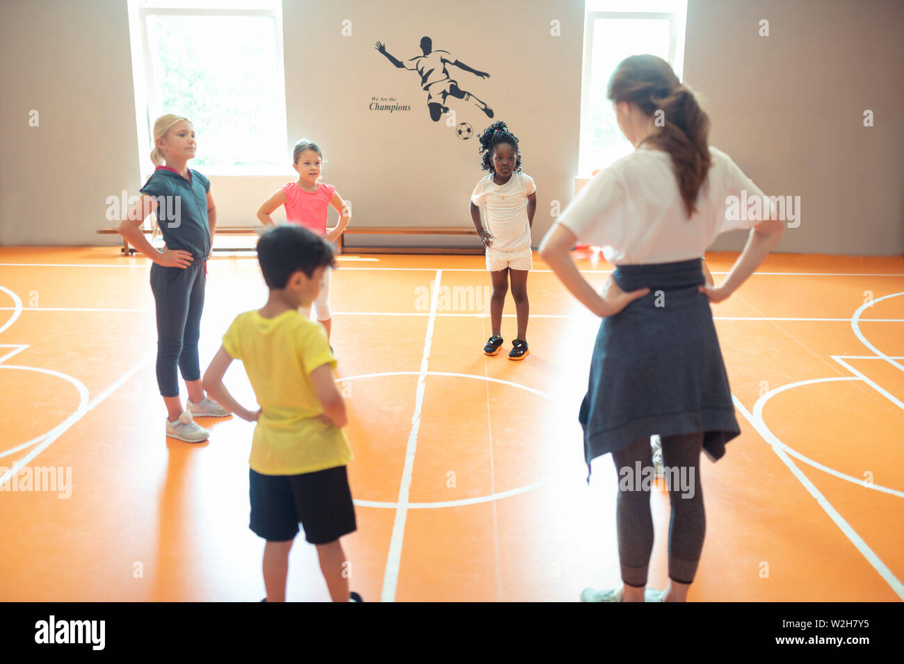 Pupils repeating exercises looking at their sports teacher Stock Photo ...
