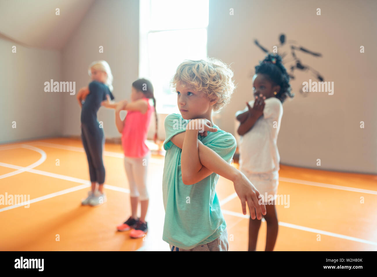 Concentrated school children at their sports lesson Stock Photo - Alamy