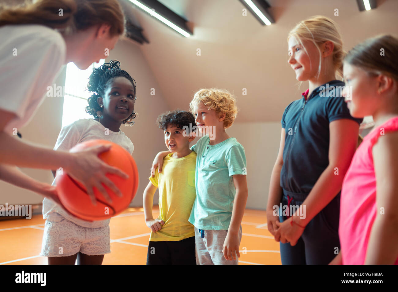Children listening to coach explaining rules of the game Stock Photo ...