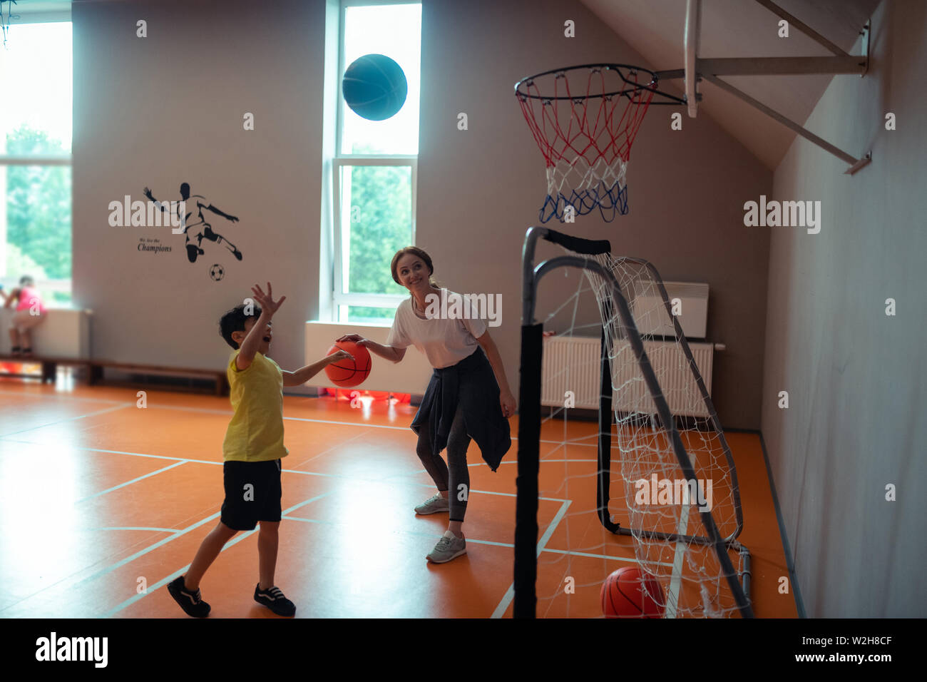 Sports teacher playing basketball with one of pupils Stock Photo - Alamy