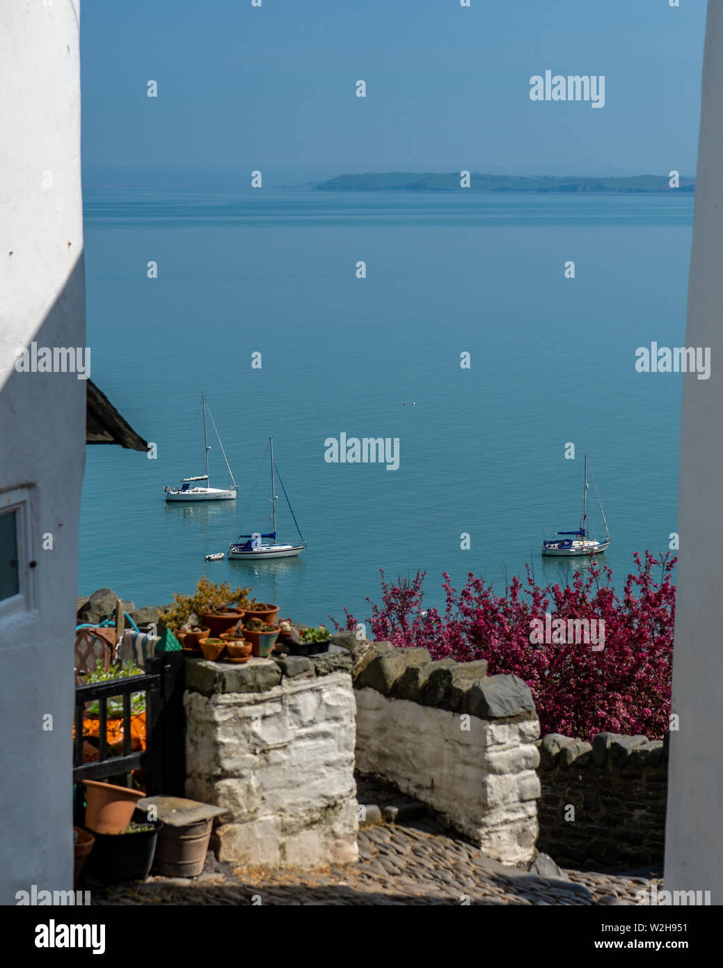 View out to Clovelly Bay from Clovelly with boats in the harbour Stock ...
