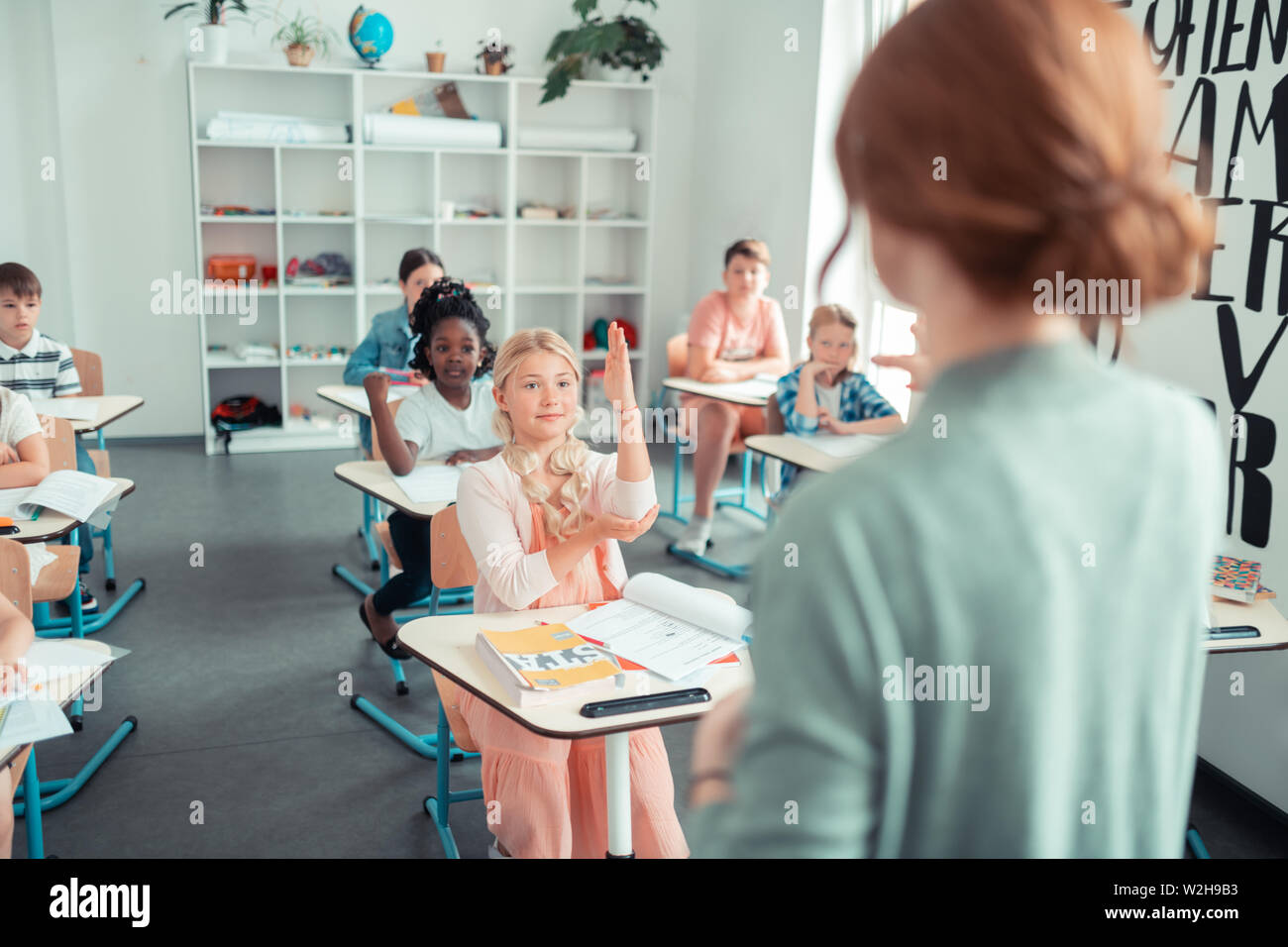 Teacher asking a question to the class Stock Photo - Alamy