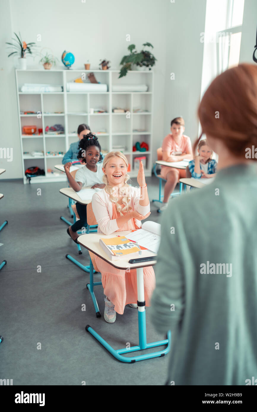 Happy pupils raising their hands class hi-res stock photography and ...