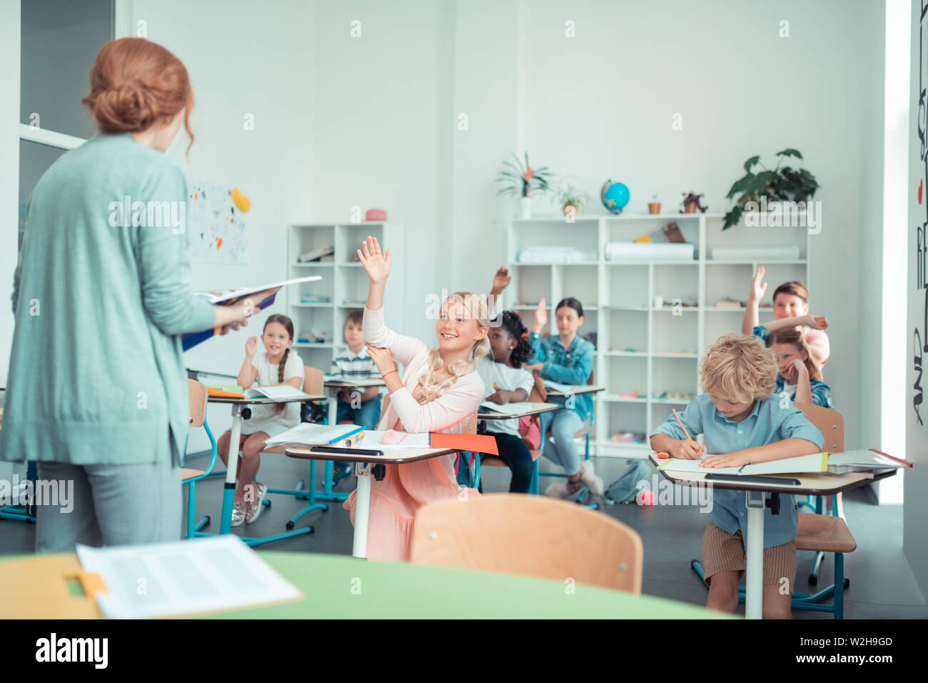 School children doing sums with their maths teacher Stock Photo - Alamy