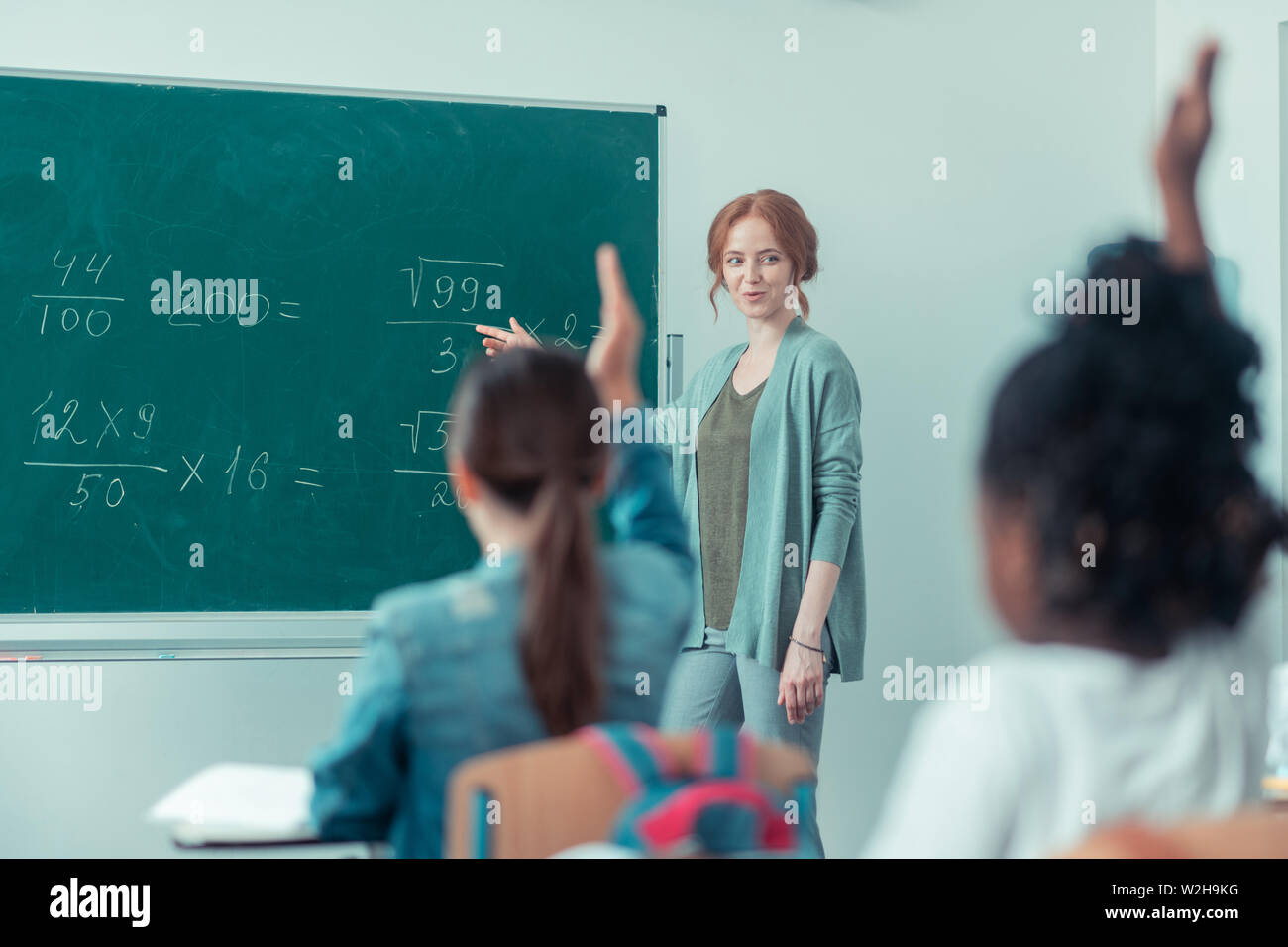 Teacher asking pupils about solution of the problem Stock Photo - Alamy