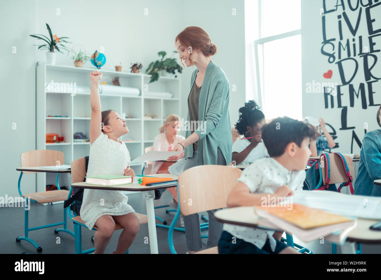 Little girl happy because of her good mark Stock Photo - Alamy