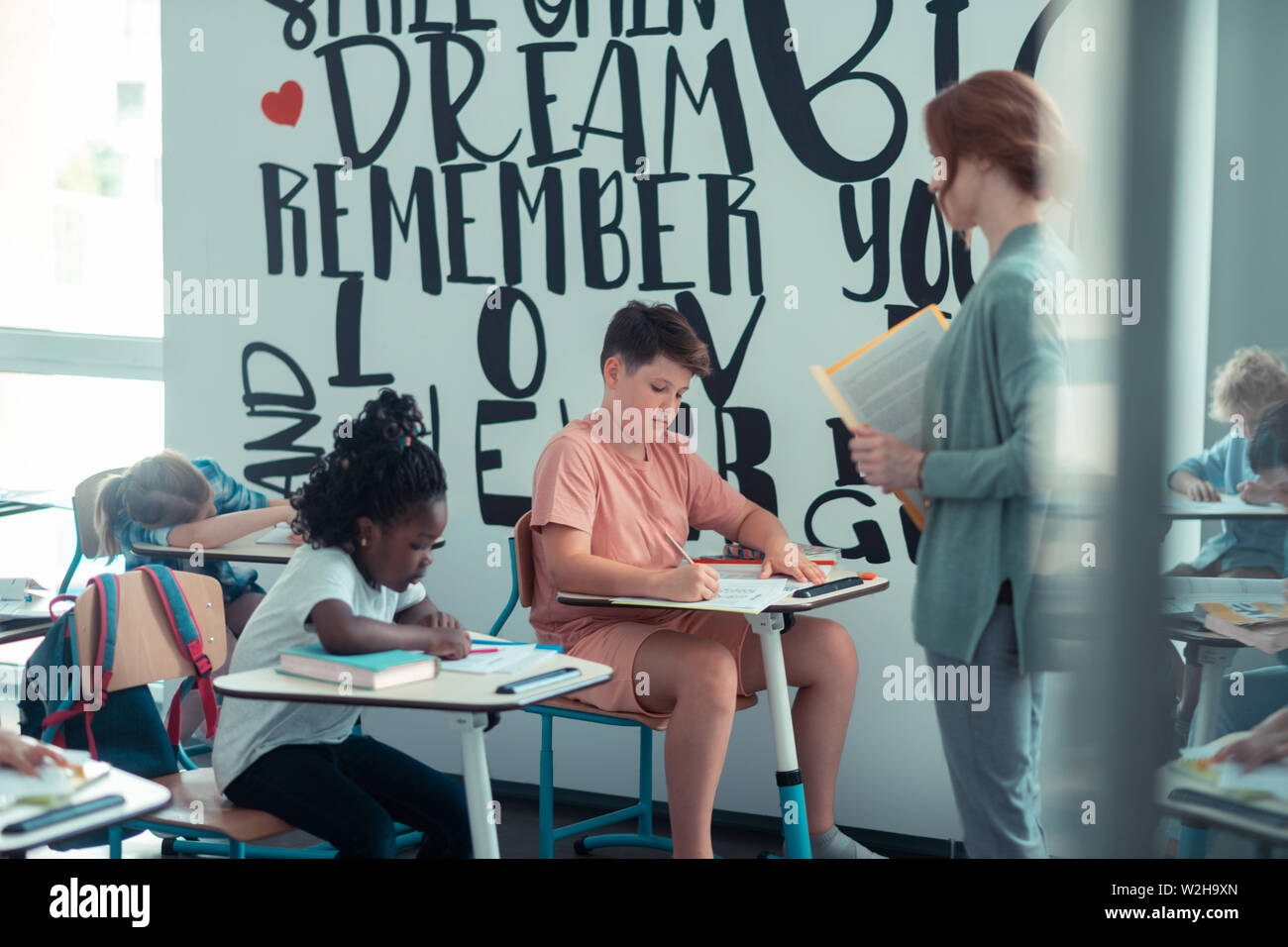 Children teacher classroom serious hi-res stock photography and images ...
