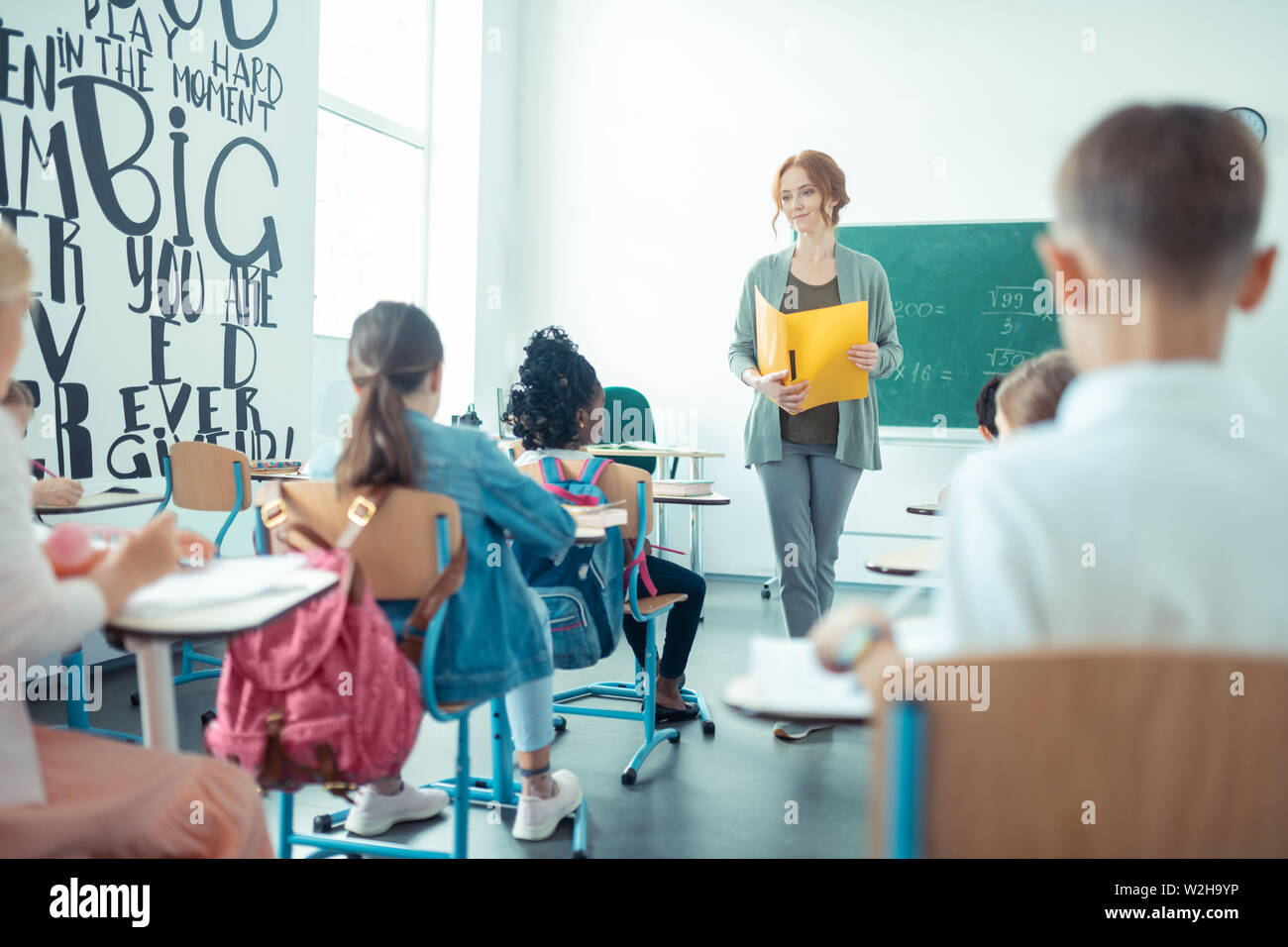 Teacher standing in front of her pupils in the classroom Stock Photo ...