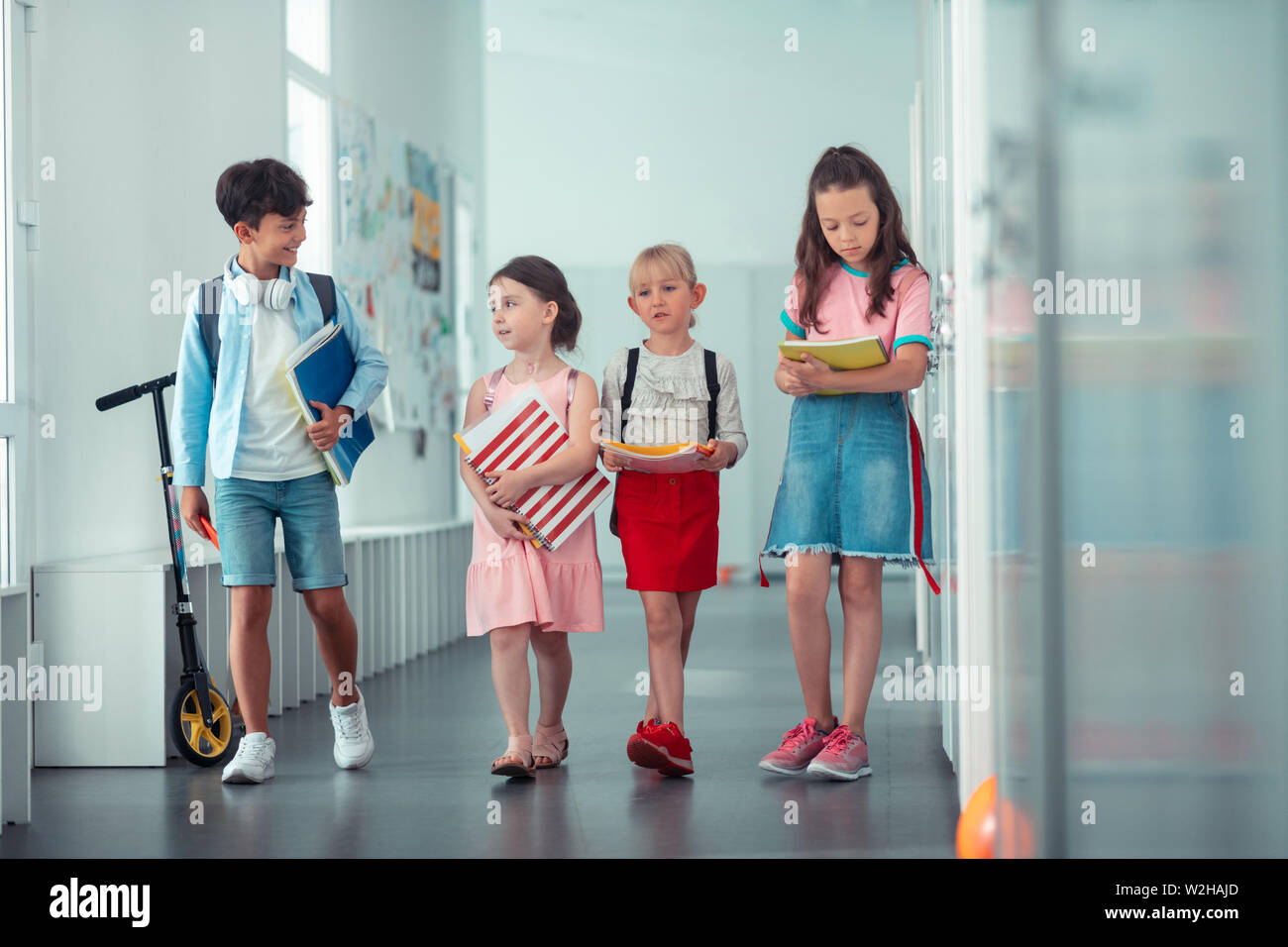 Children holding their notebooks while going to the lesson Stock Photo ...