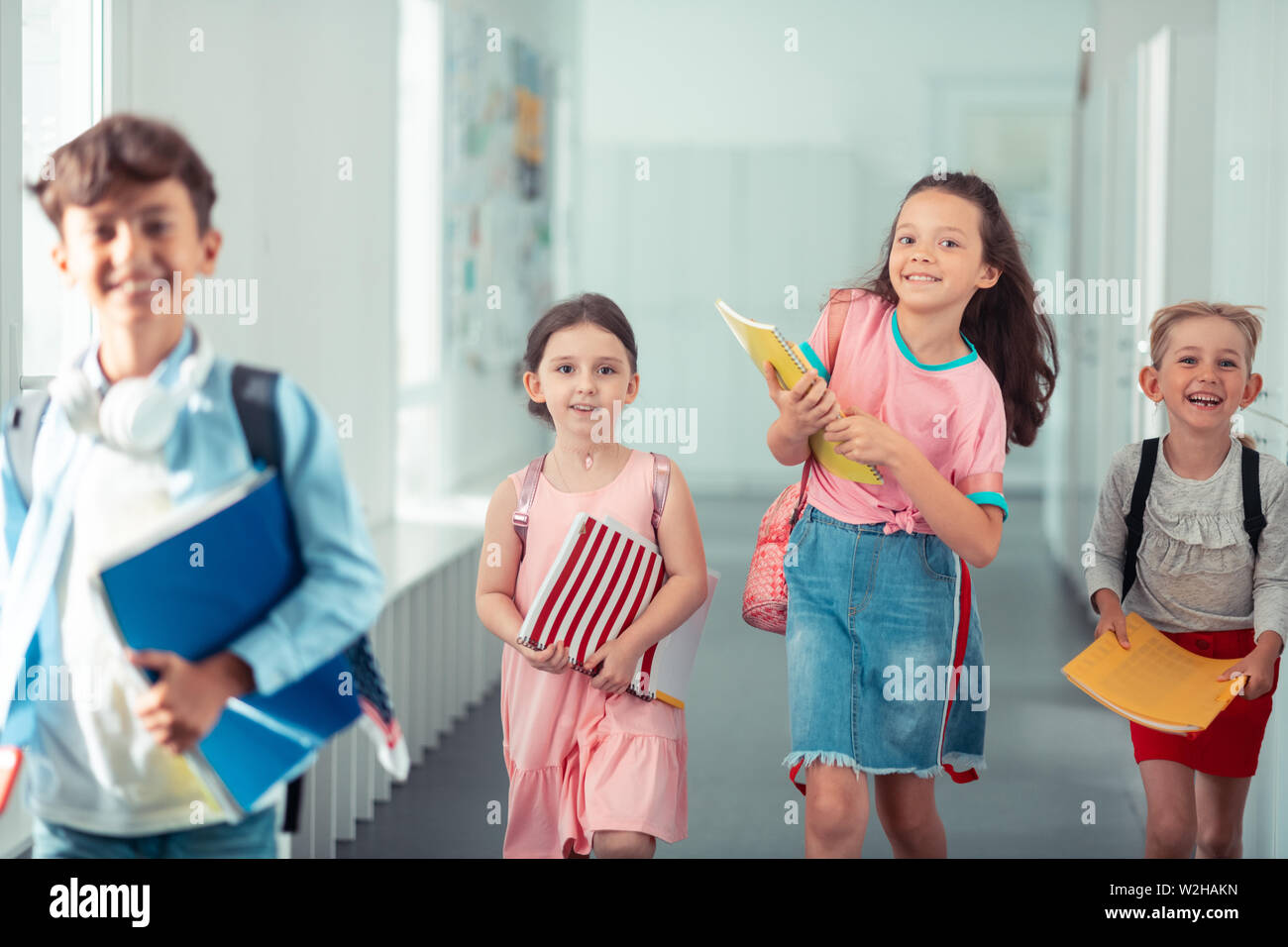 Girls and boy feeling happy going home from school Stock Photo - Alamy