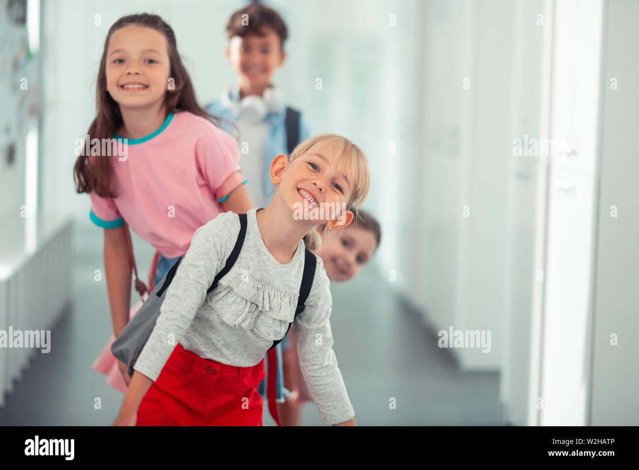 Beautiful blonde-haired girl spending time with friends at school Stock ...
