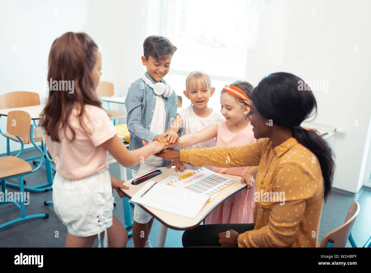 Children and teacher enjoying their team work all together Stock Photo ...