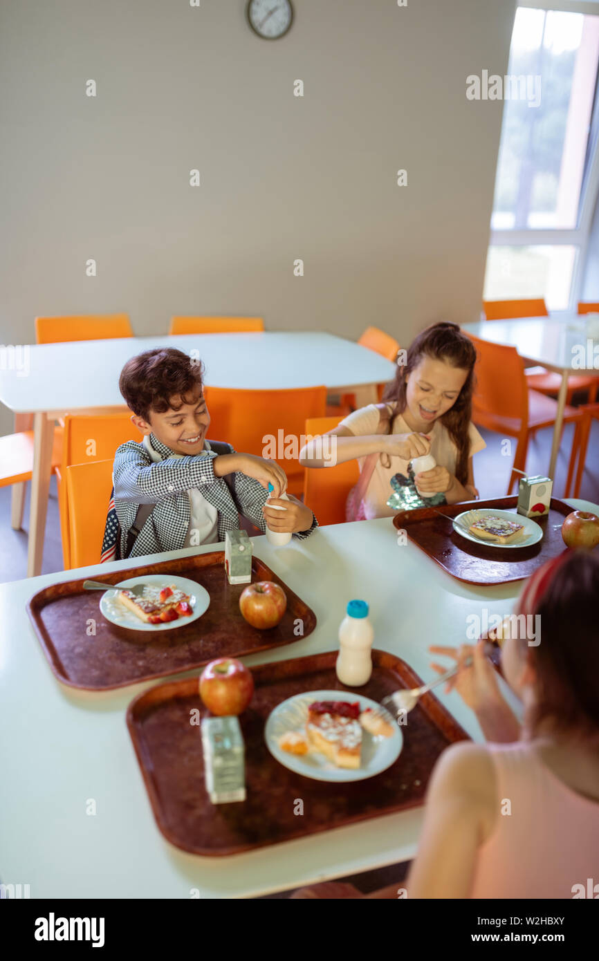 Friends eating together at canteen hi-res stock photography and images ...