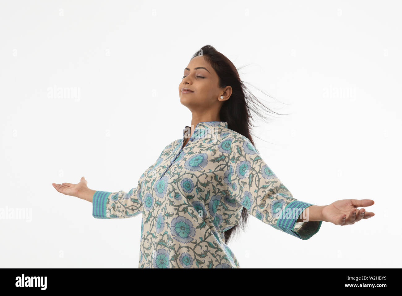 Woman standing with her arm outstretched Stock Photo - Alamy