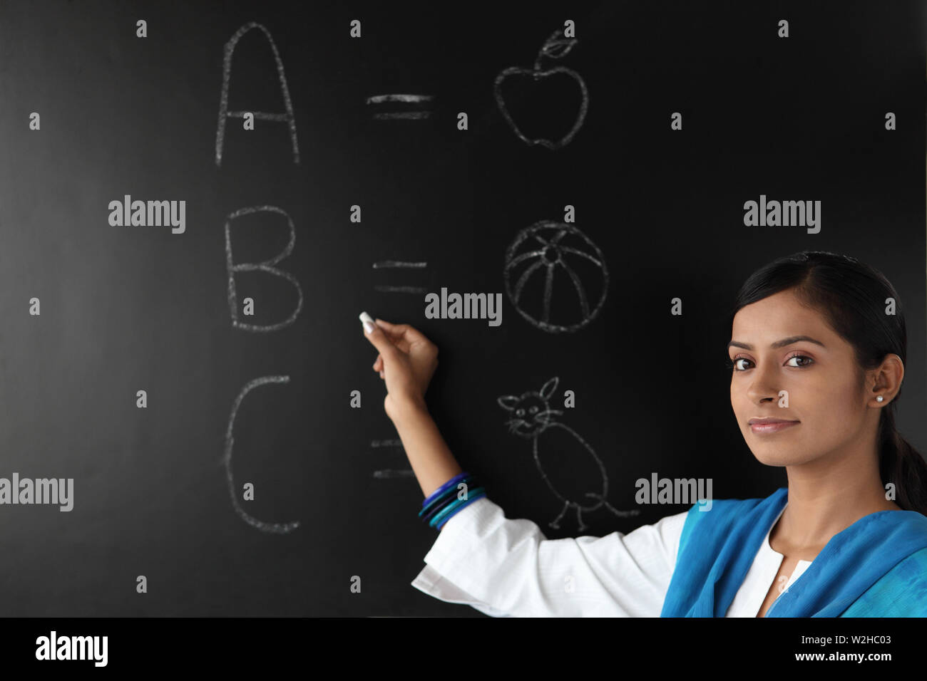 Teacher teaching in a classroom Stock Photo - Alamy