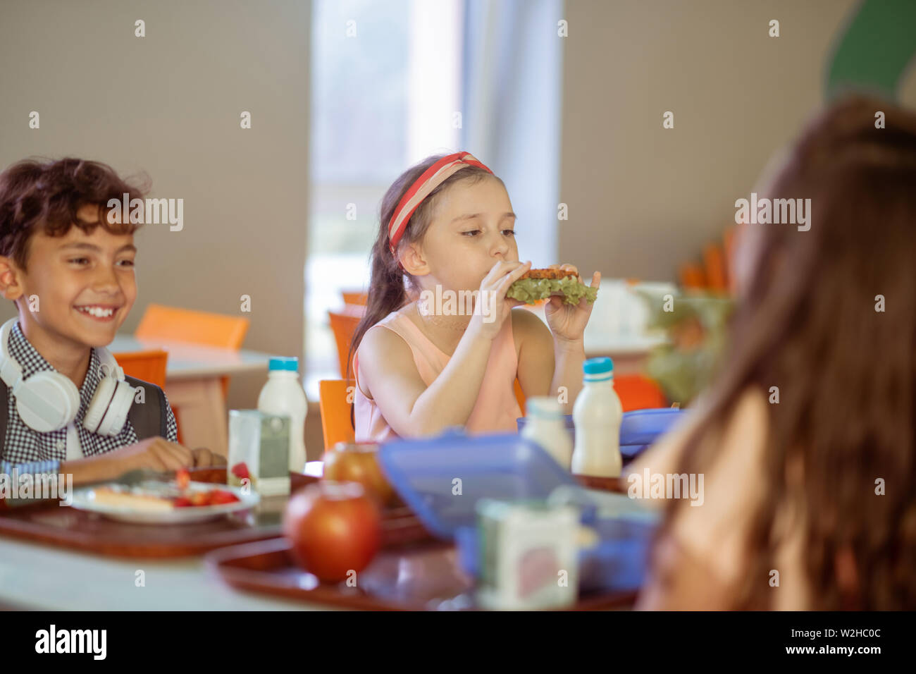 Friends eating together at canteen hi-res stock photography and images ...