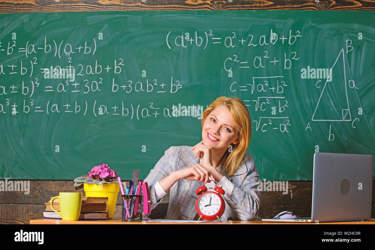 take your time. teacher with alarm clock at blackboard. Time. Study and ...