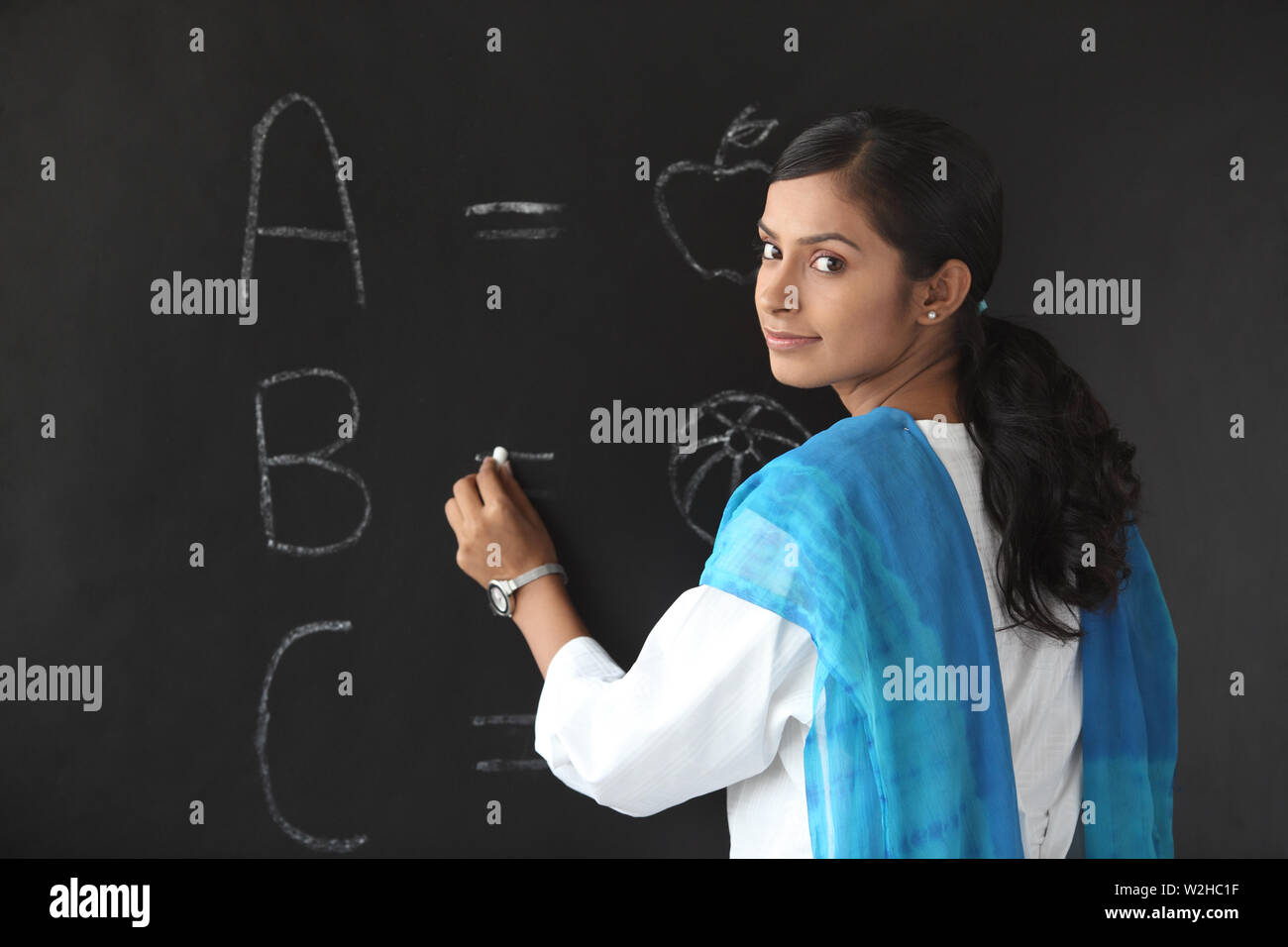 Teacher teaching in a classroom Stock Photo - Alamy