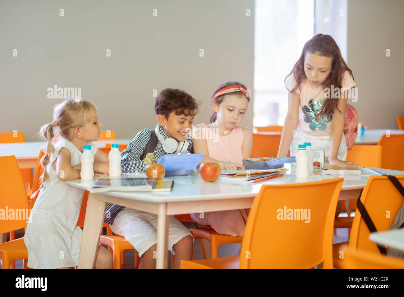 Children feeling busy while learning poem and eating lunch Stock Photo ...
