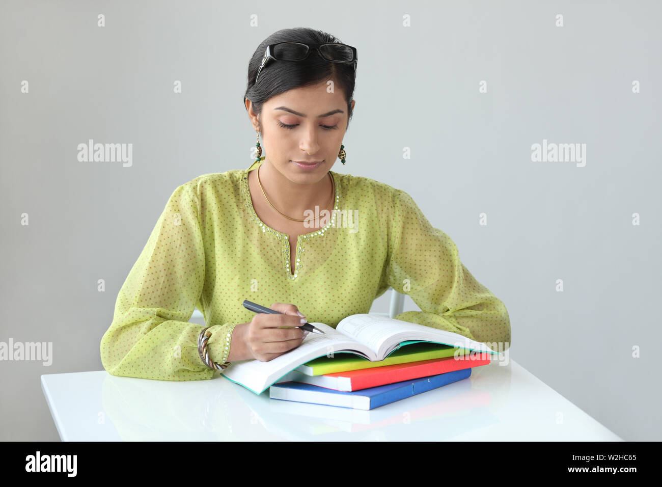 College student reading a book Stock Photo - Alamy