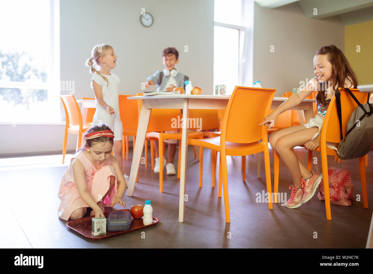 Children bullying little girl dropping tray with food in canteen Stock ...