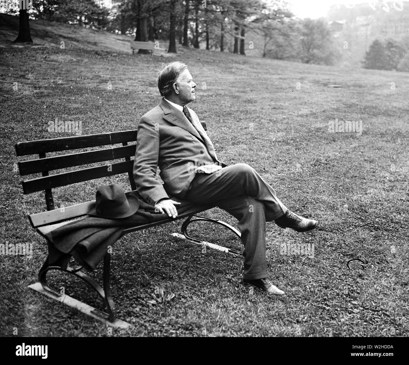 Man sitting on a park bench, William E. Borah, ca. 1936 Stock Photo - Alamy
