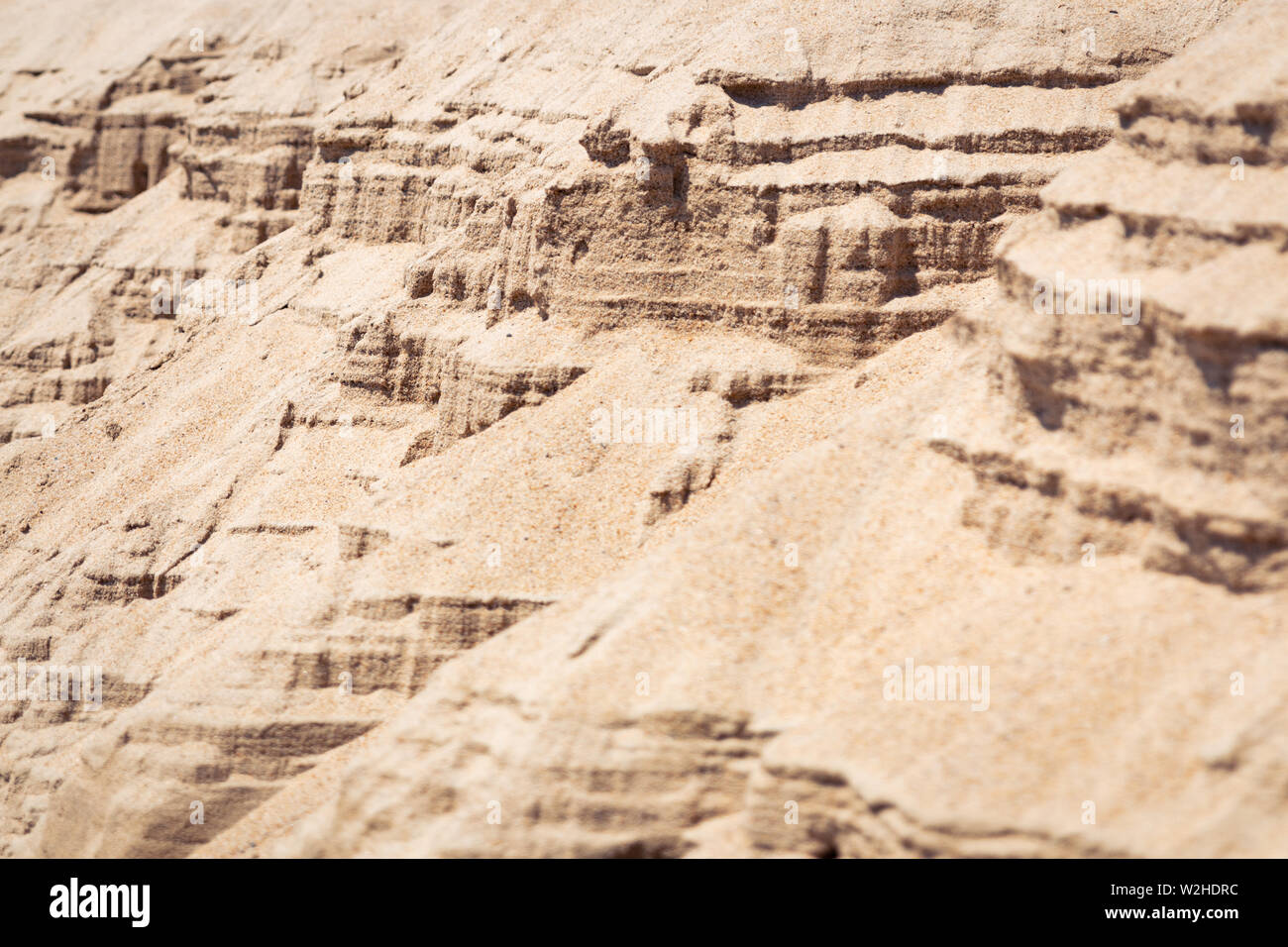 Warm colors background. Yellow sandstone textured mountain, white thin ...