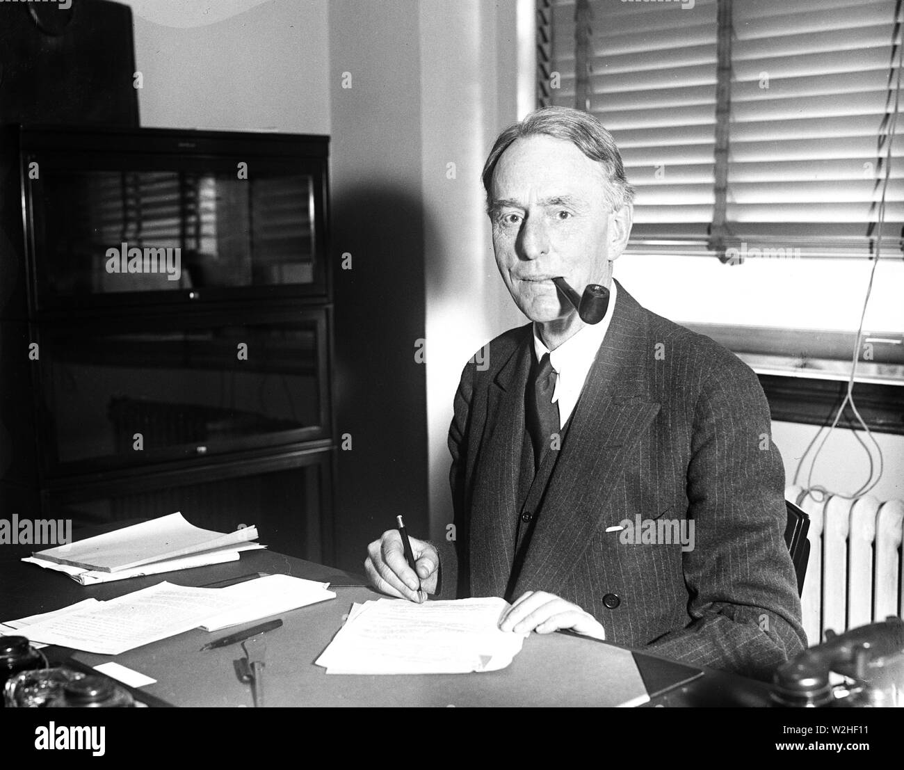 Doctor or nurse sitting behind a desk Black and White Stock Photos ...