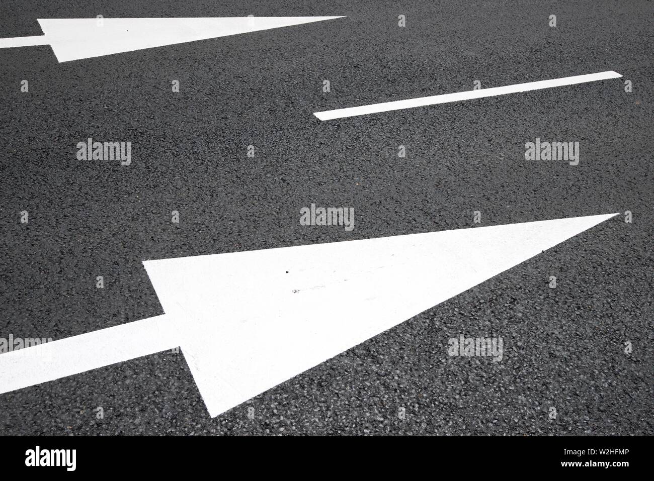 Two arrow directional signals on the floor Stock Photo - Alamy