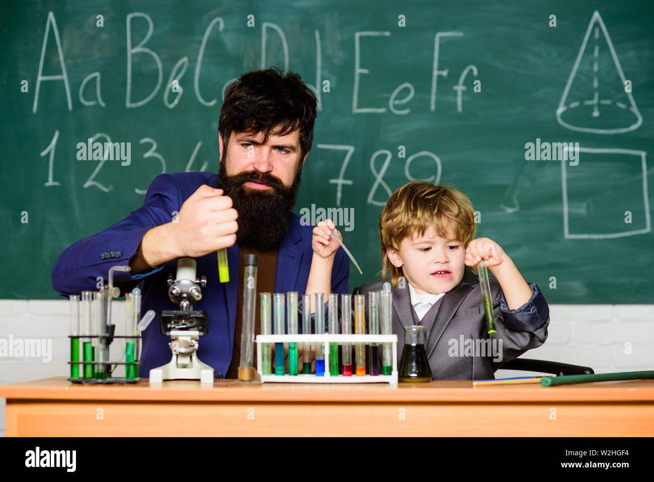 Laboratory test tubes and flasks with colored liquids bearded man ...