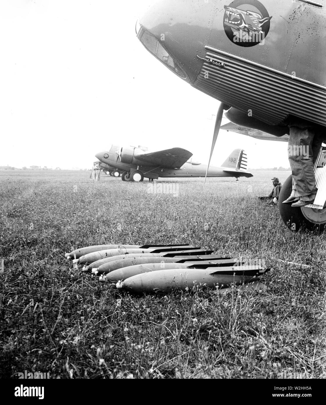 Airplane with bombs lying on the ground in front of it ca. 1936 Stock ...