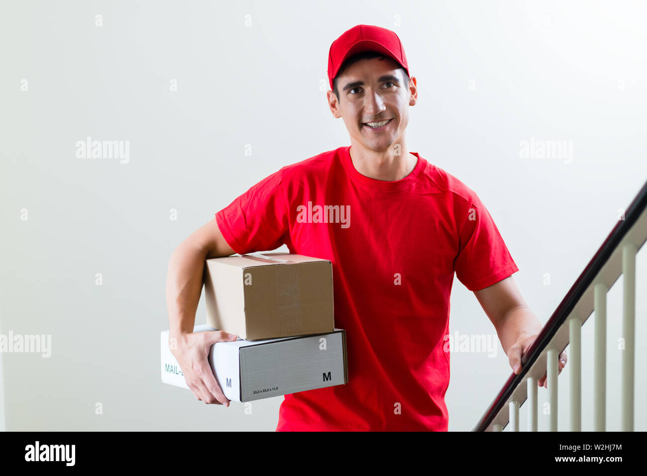 Happy delivery man parcel boxes hi-res stock photography and images - Alamy