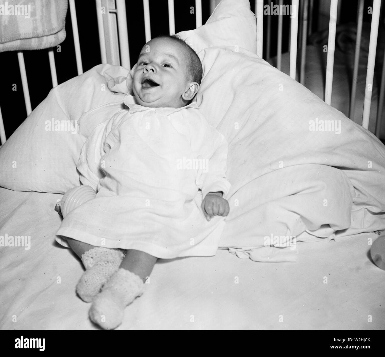 Toddler in a crib ca. 1935 Stock Photo - Alamy