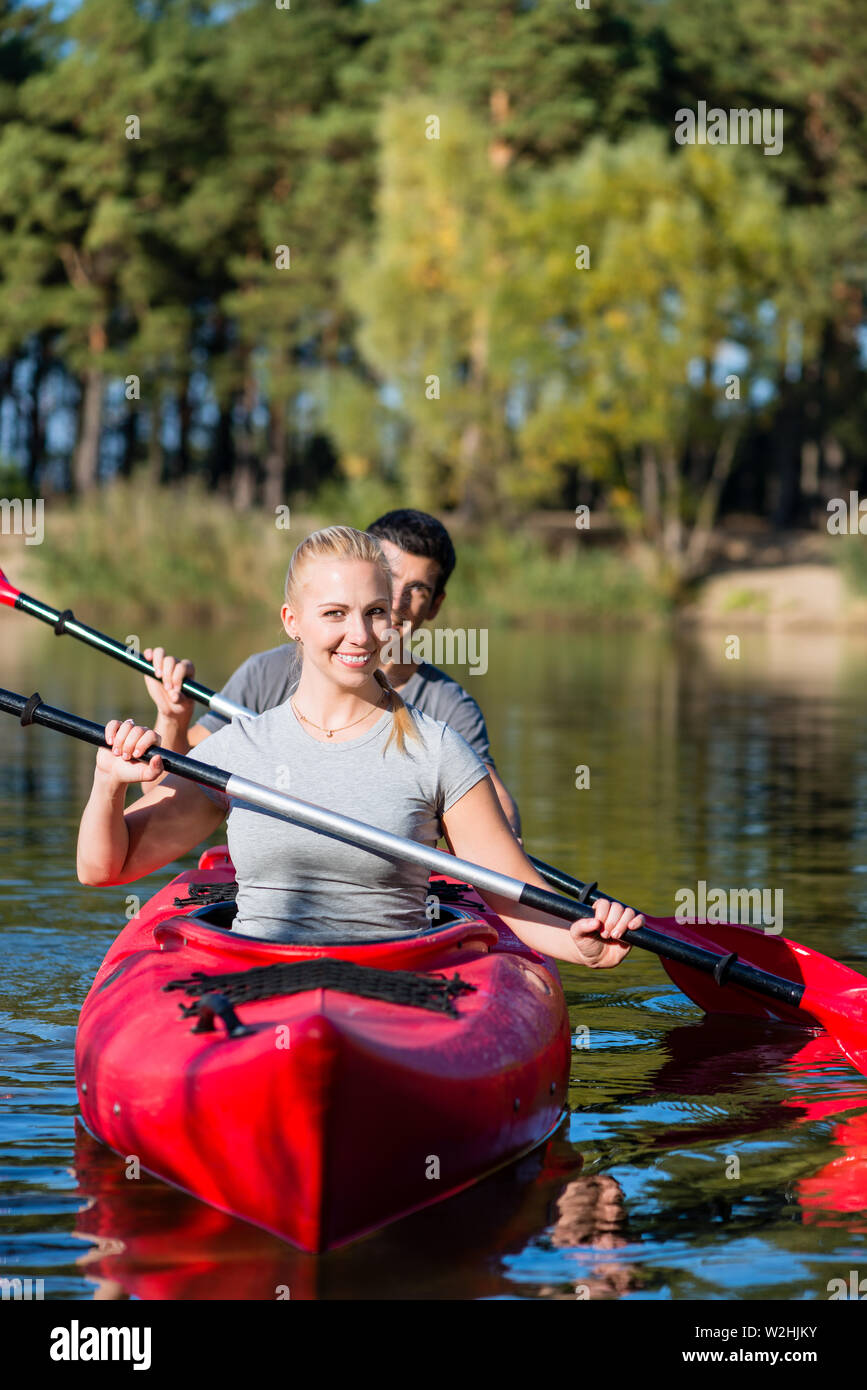 Happy couple kayaking Stock Photo - Alamy