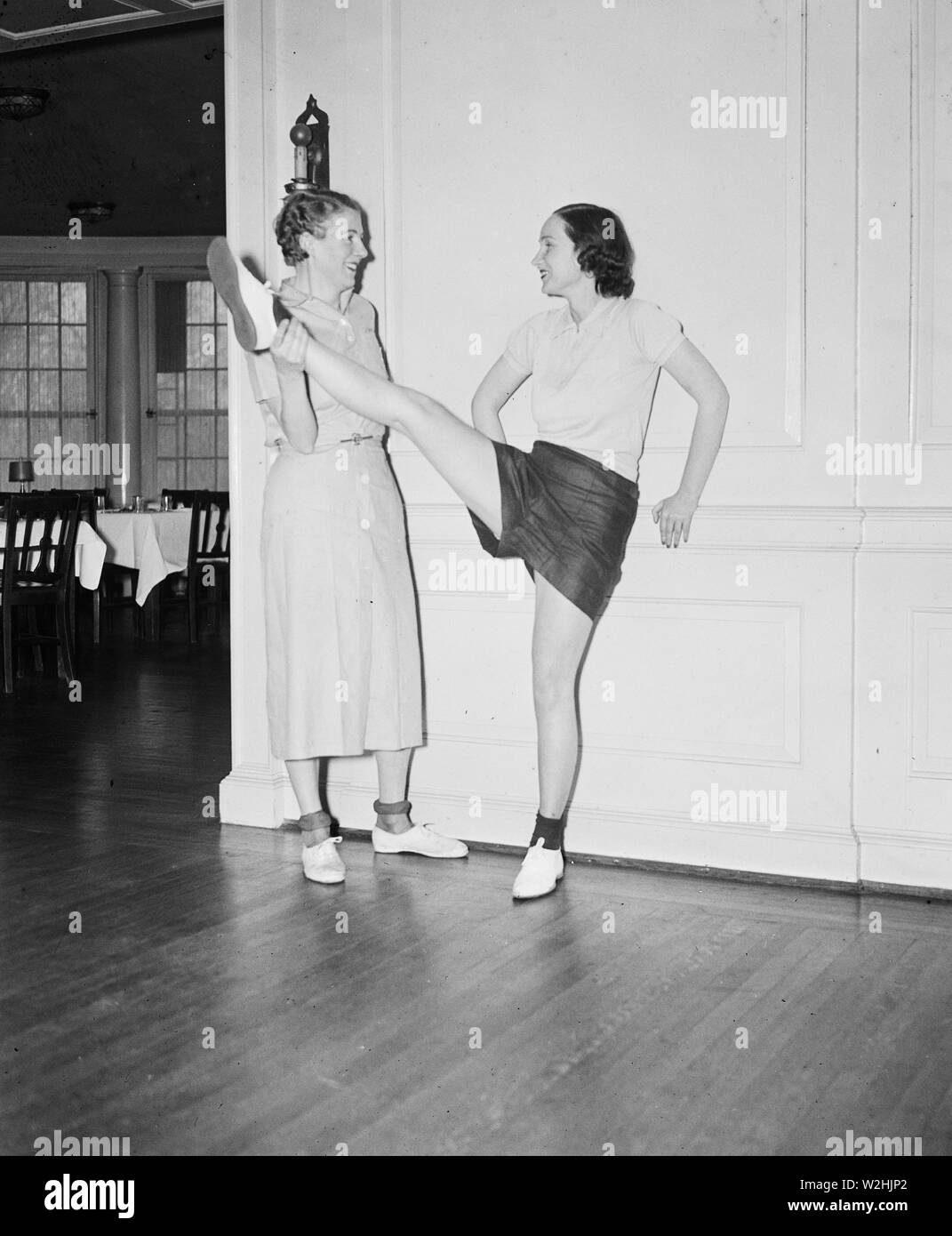 Dancer in a dance studio stretching her leg ca. 1936 Stock Photo - Alamy