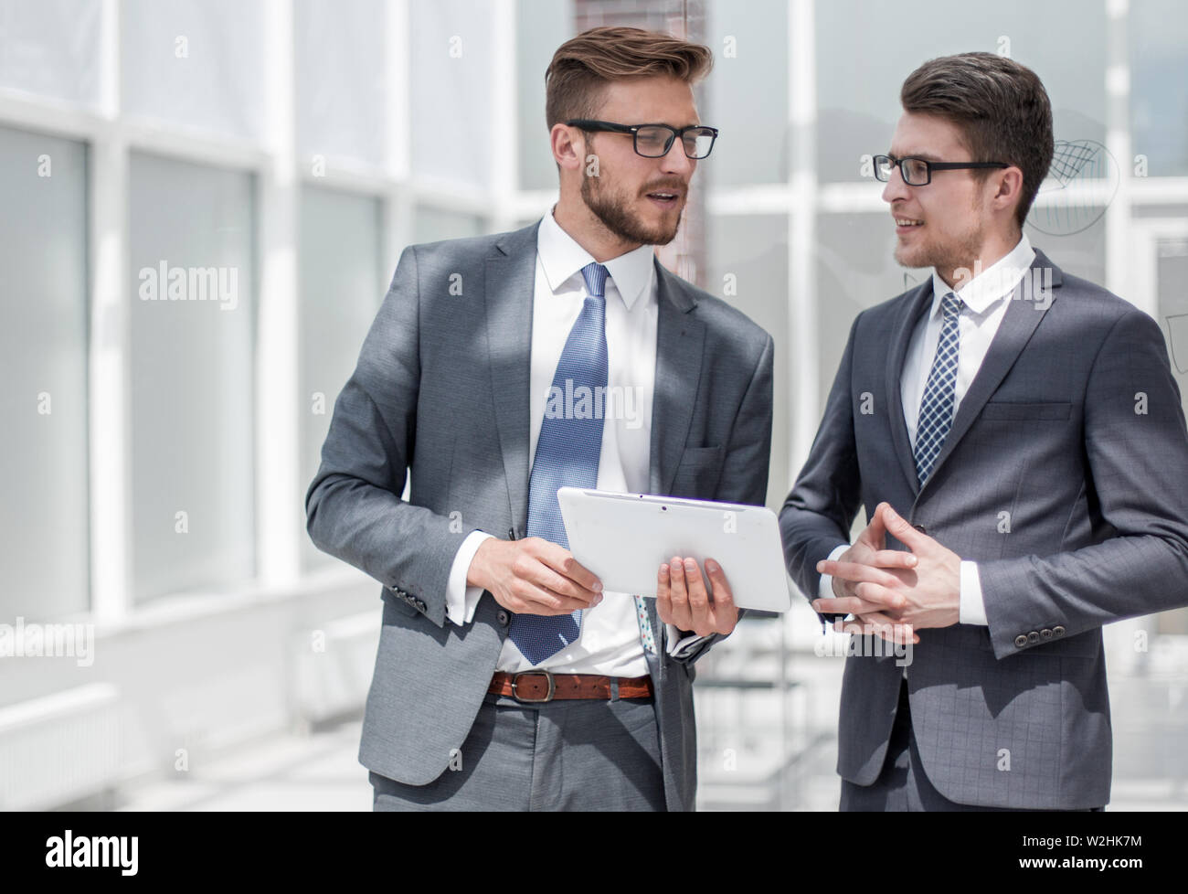 two employees standing in the office Stock Photo - Alamy