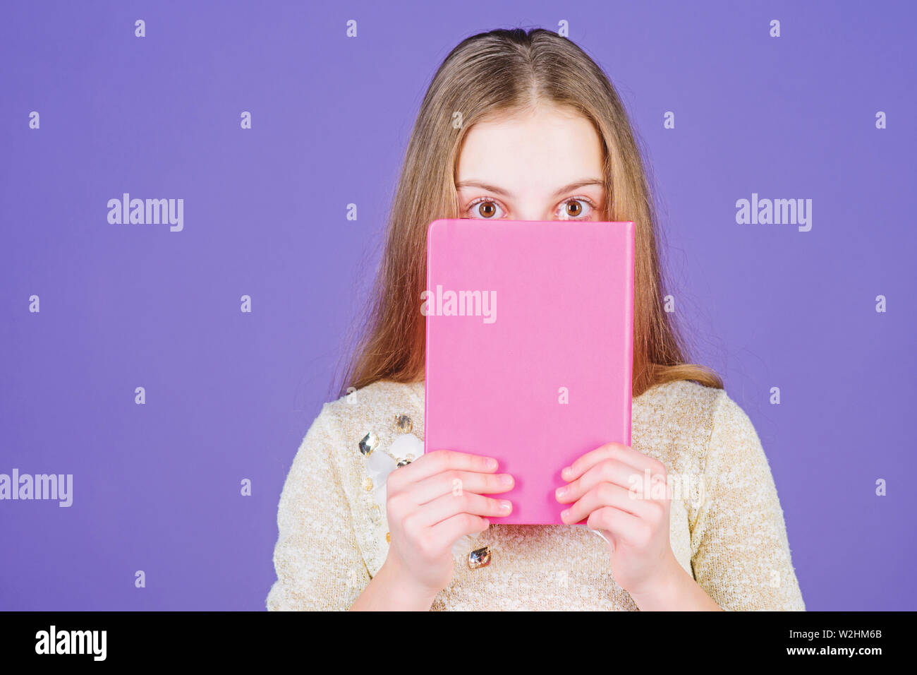 Education is about widening knowledge. Adorable small girl covering ...