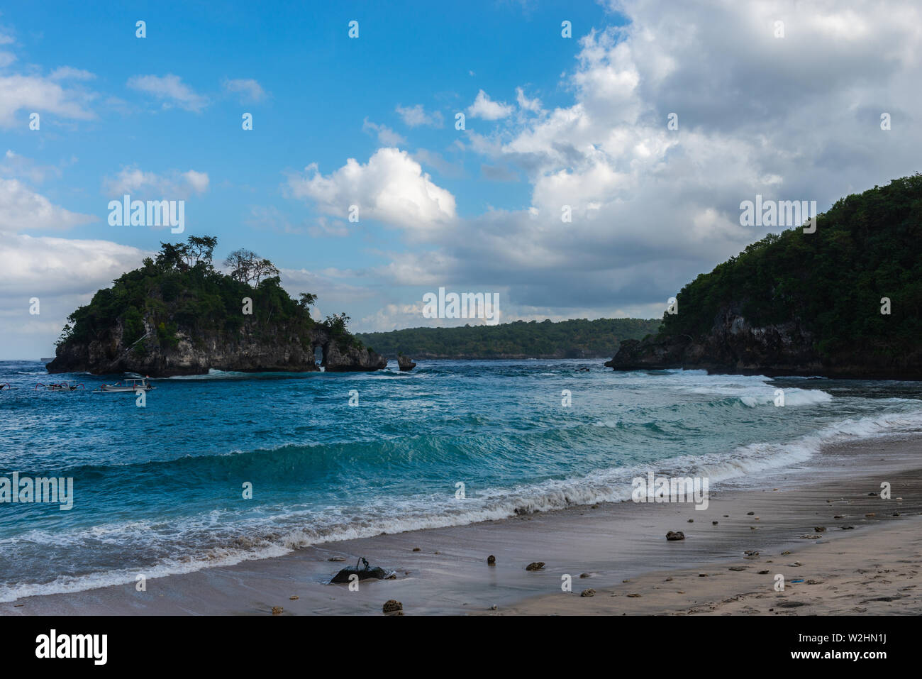 View of tropical beach, sea rocks and turquoise ocean, blue sky ...