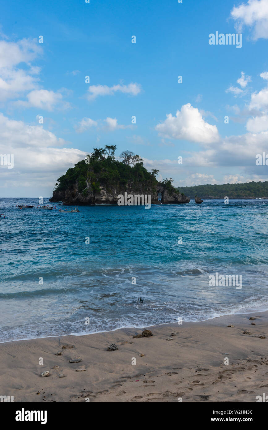 View of tropical beach, sea rocks and turquoise ocean, blue sky ...