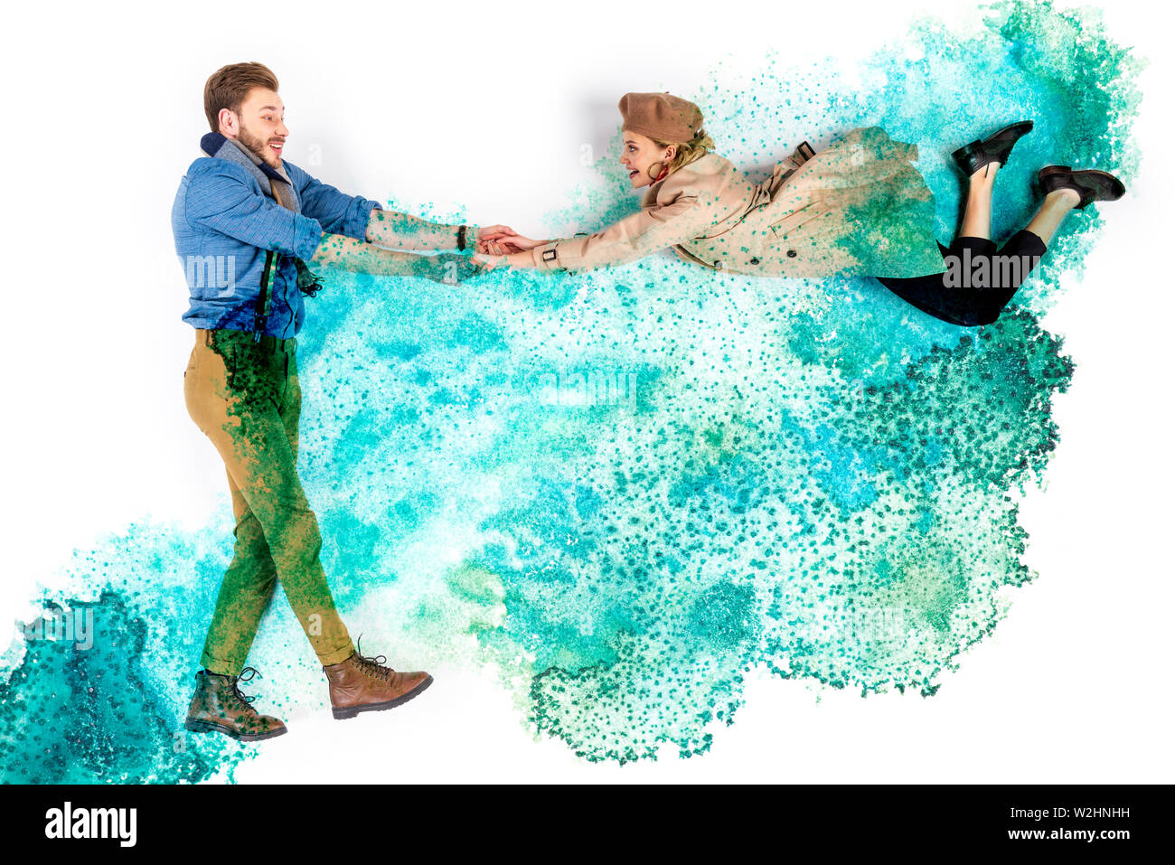 elegant woman levitating in air and holding hands with man on ...