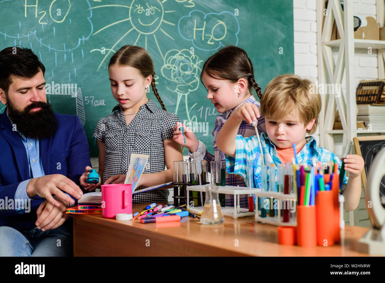 students doing science experiments with microscope in lab. school kids ...