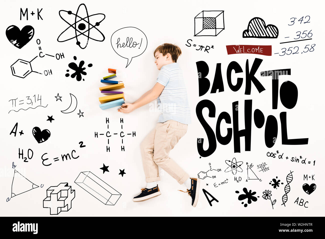 top view of kid near colorful books and welcome back to school ...