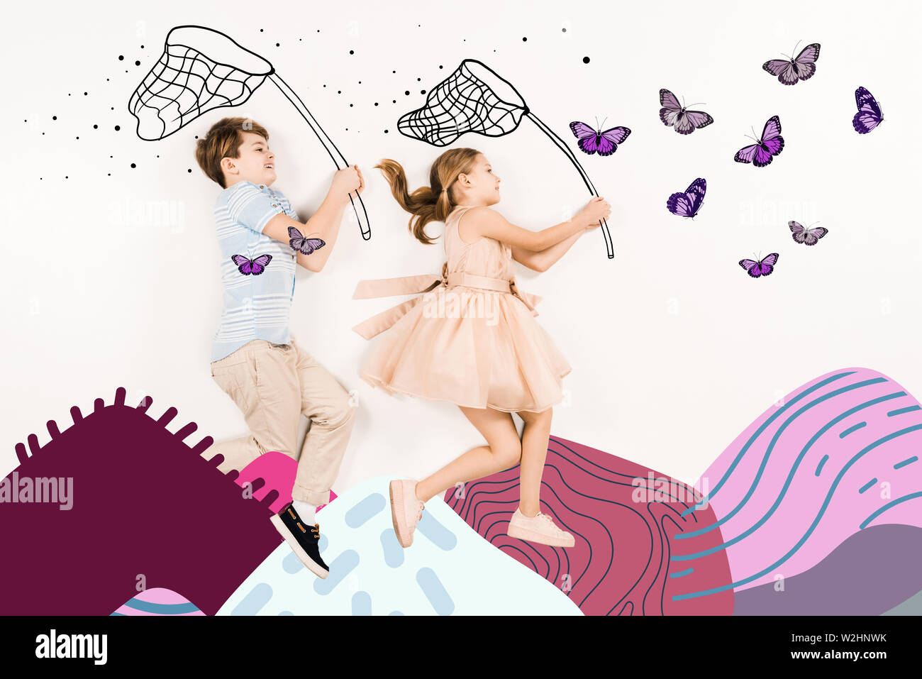 top view of cheerful kids with butterfly nets near butterflies and ...