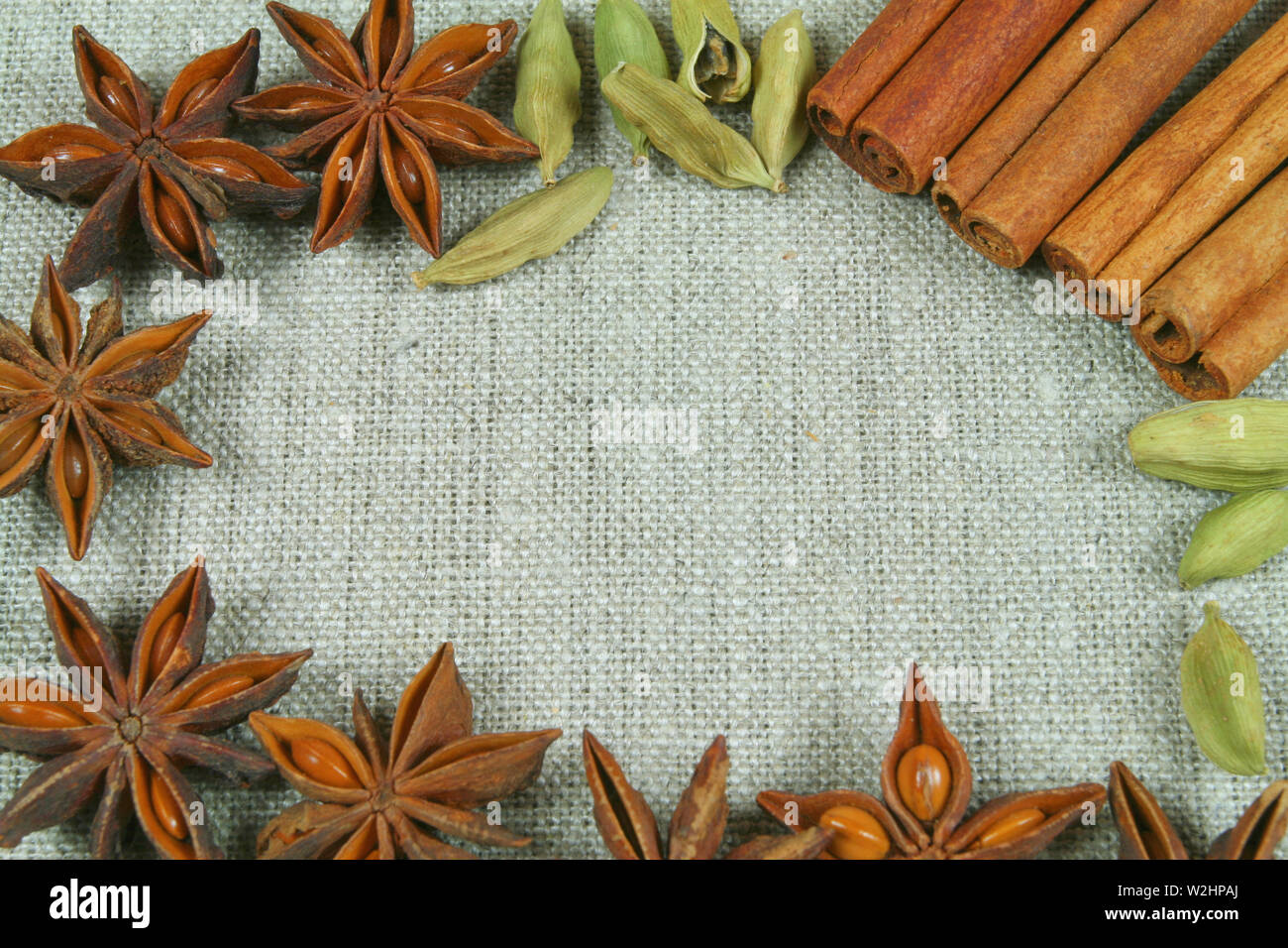 Frame of Christmas spices - anise stars green cardamom and cinnamon ...