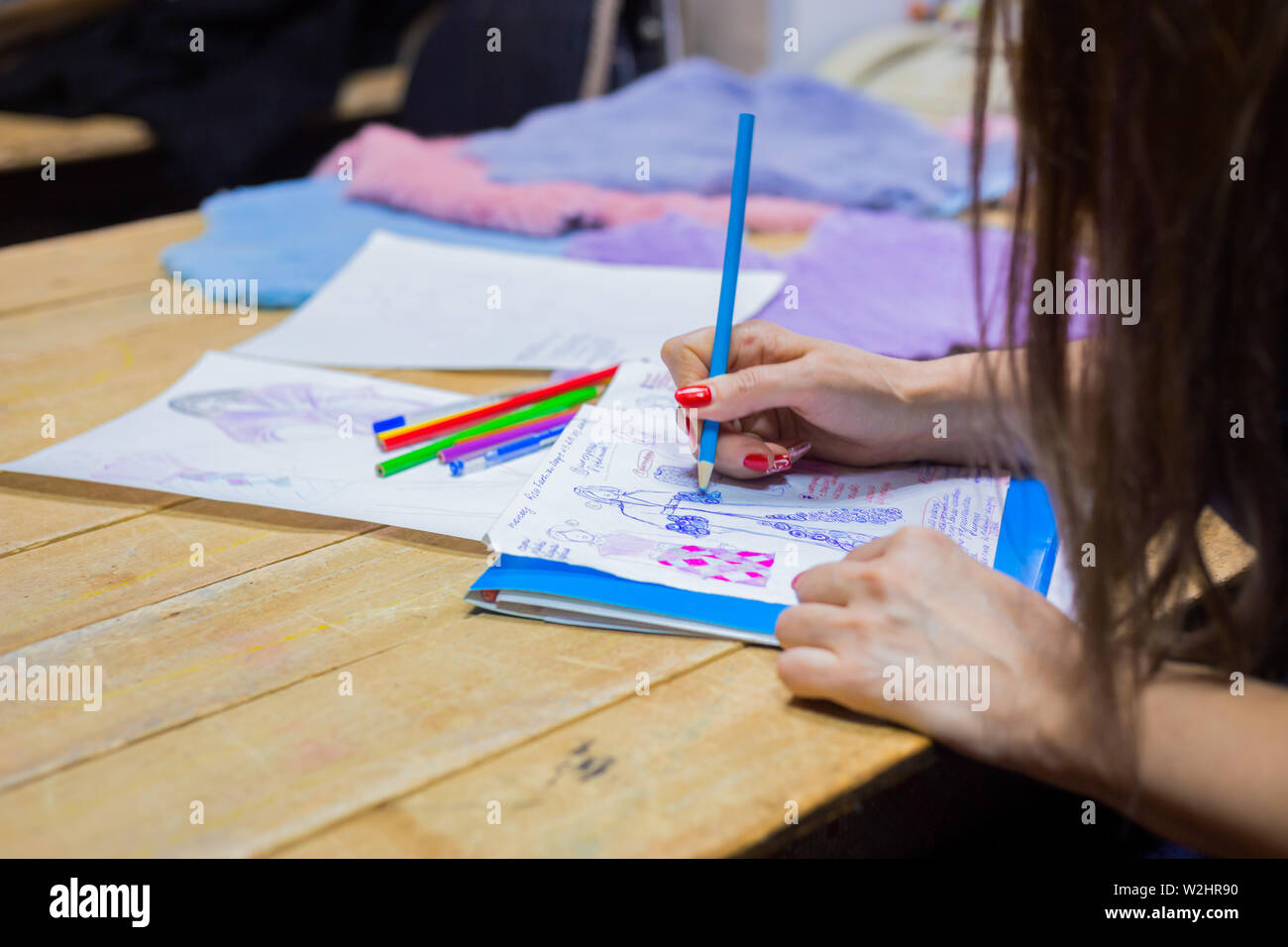 Fashion designer drawing design sketch Stock Photo - Alamy