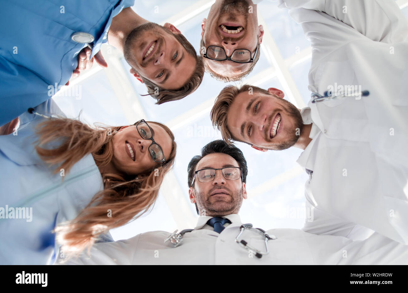 doctors looking down smiling at the camera Stock Photo - Alamy
