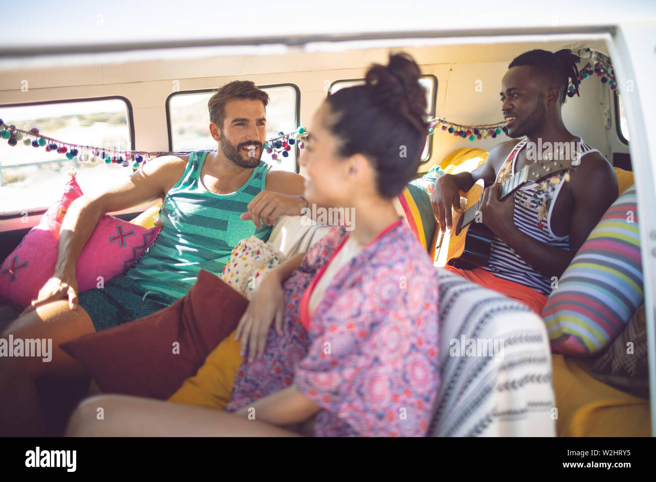 Group of friends having fun in a camper van at beach Stock Photo - Alamy