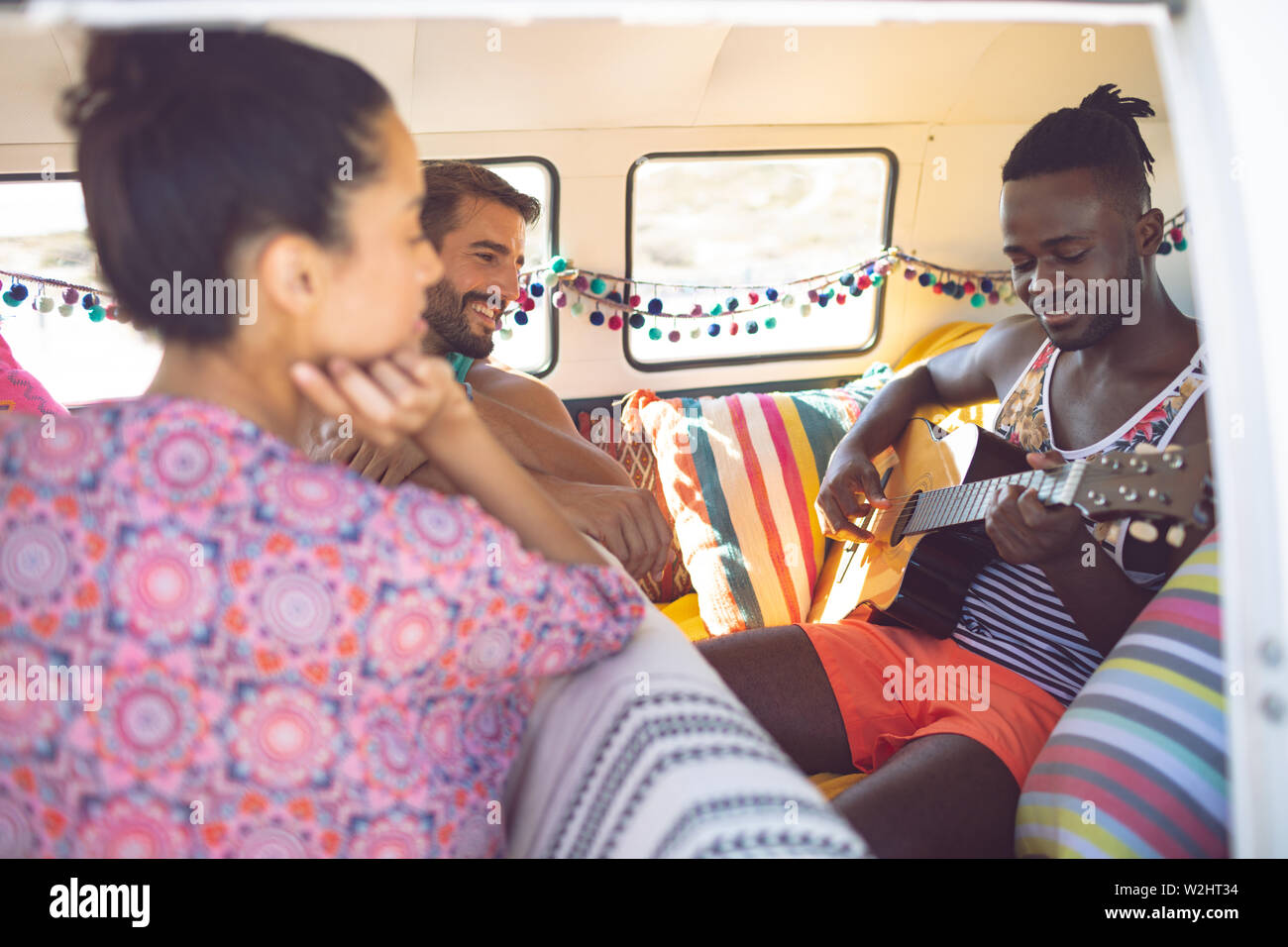 Group of friends having fun in a camper van at beach Stock Photo - Alamy
