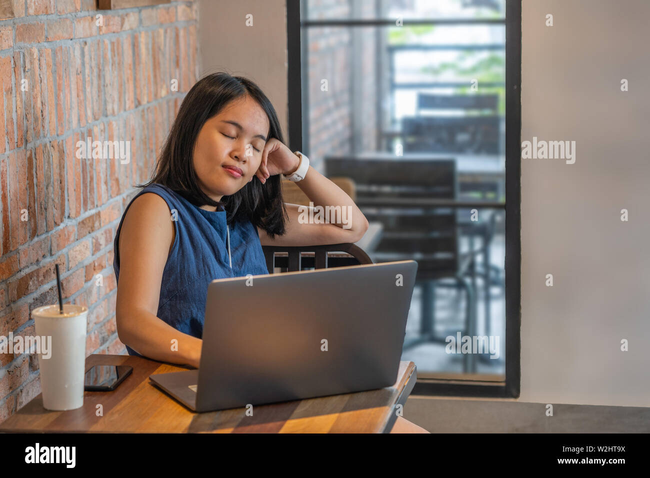 Restless woman closing her eyes while working on computer Stock Photo ...